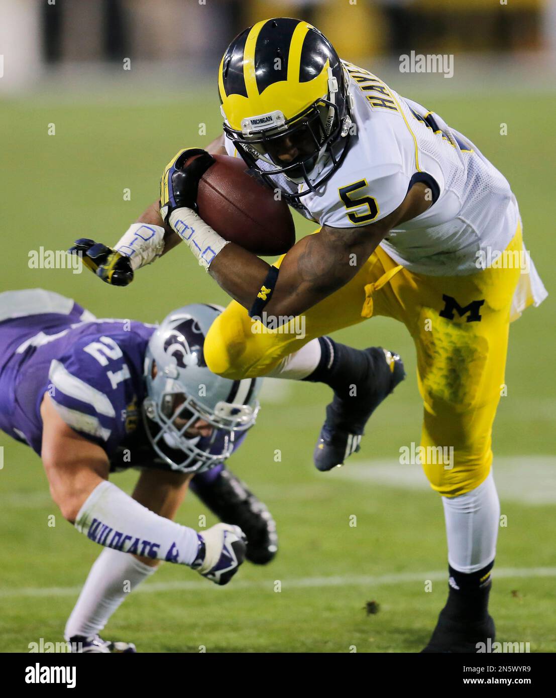 Michigan running back Justice Hayes (5) slips past Kansas State ...