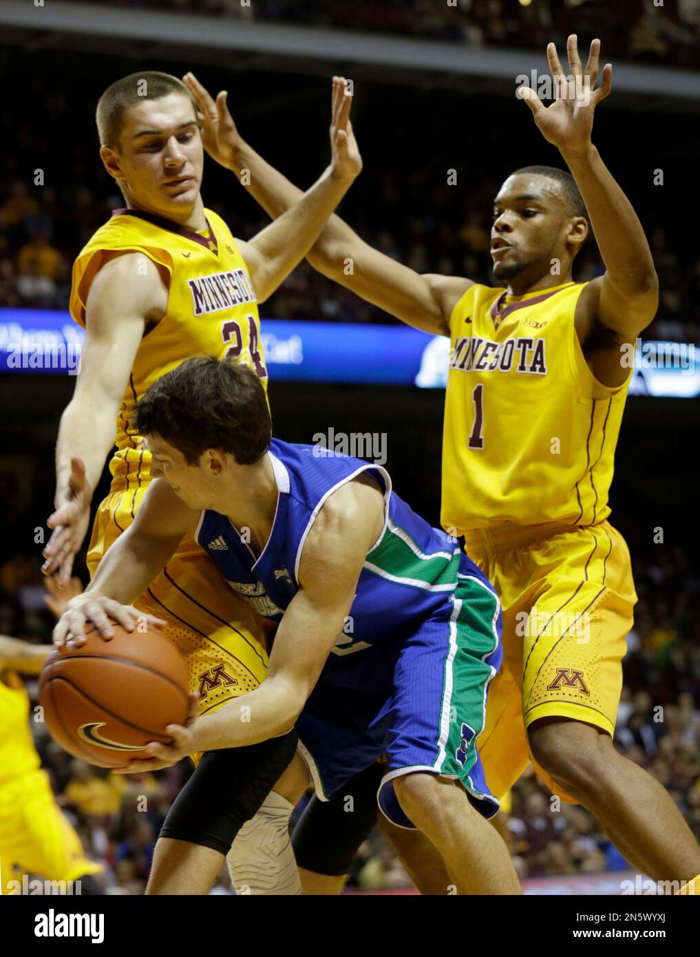 Texas A&M Corpus Christi guard Jake Kocher, center, is trapped by ...
