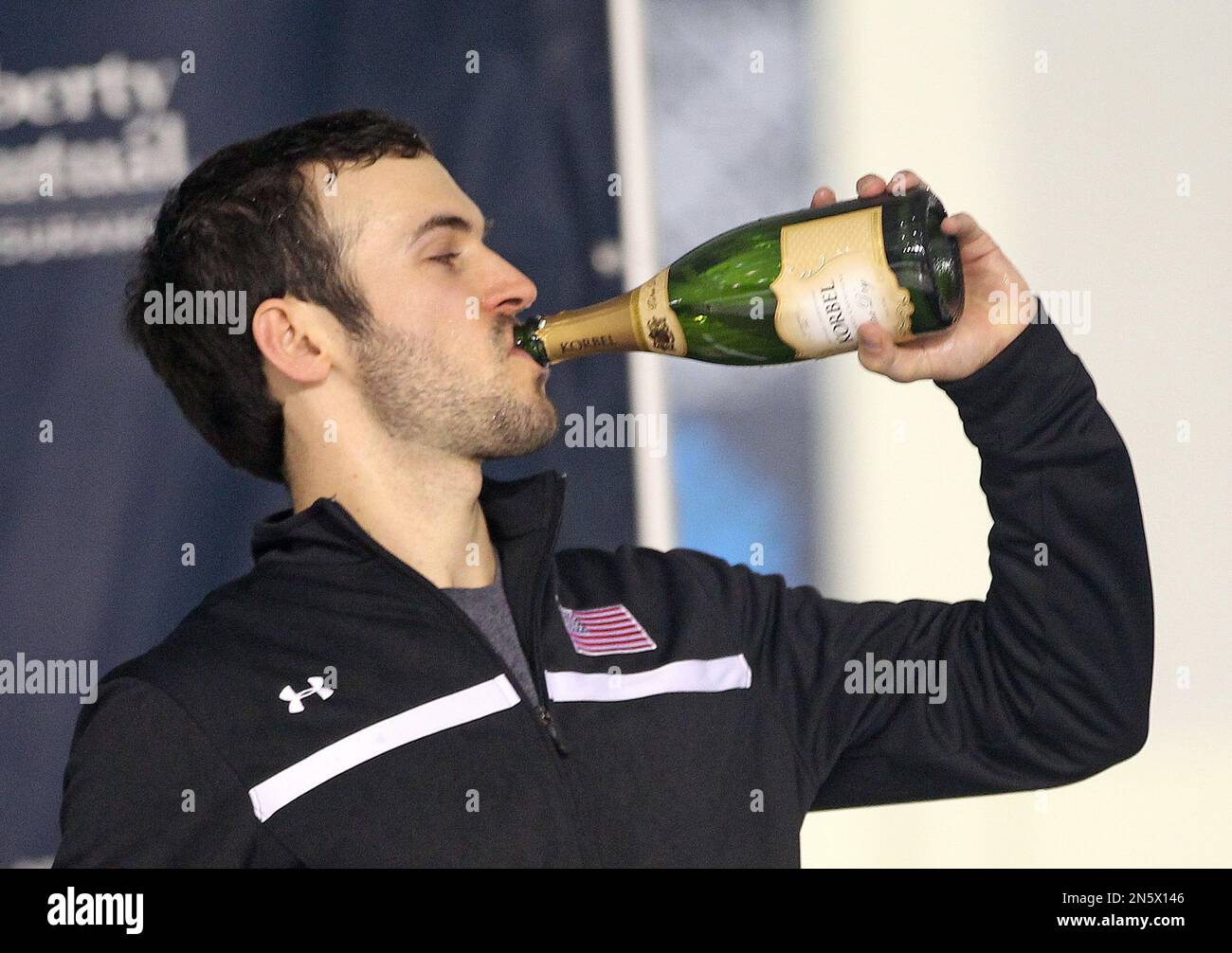 Mitchell Whitmore drinks sparkling wine on the podium following his win ...
