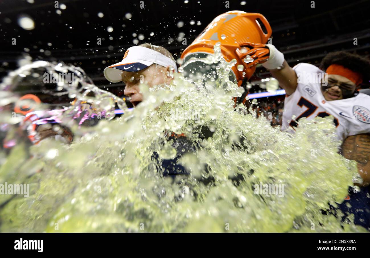 Syracuse coach Scott Shafer is doused after winning the Texas Bowl NCAA ...