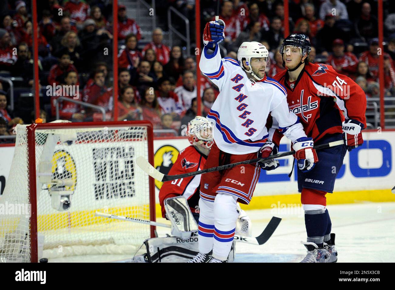 New York Rangers left wing Benoit Pouliot, center, celebrates his goal ...