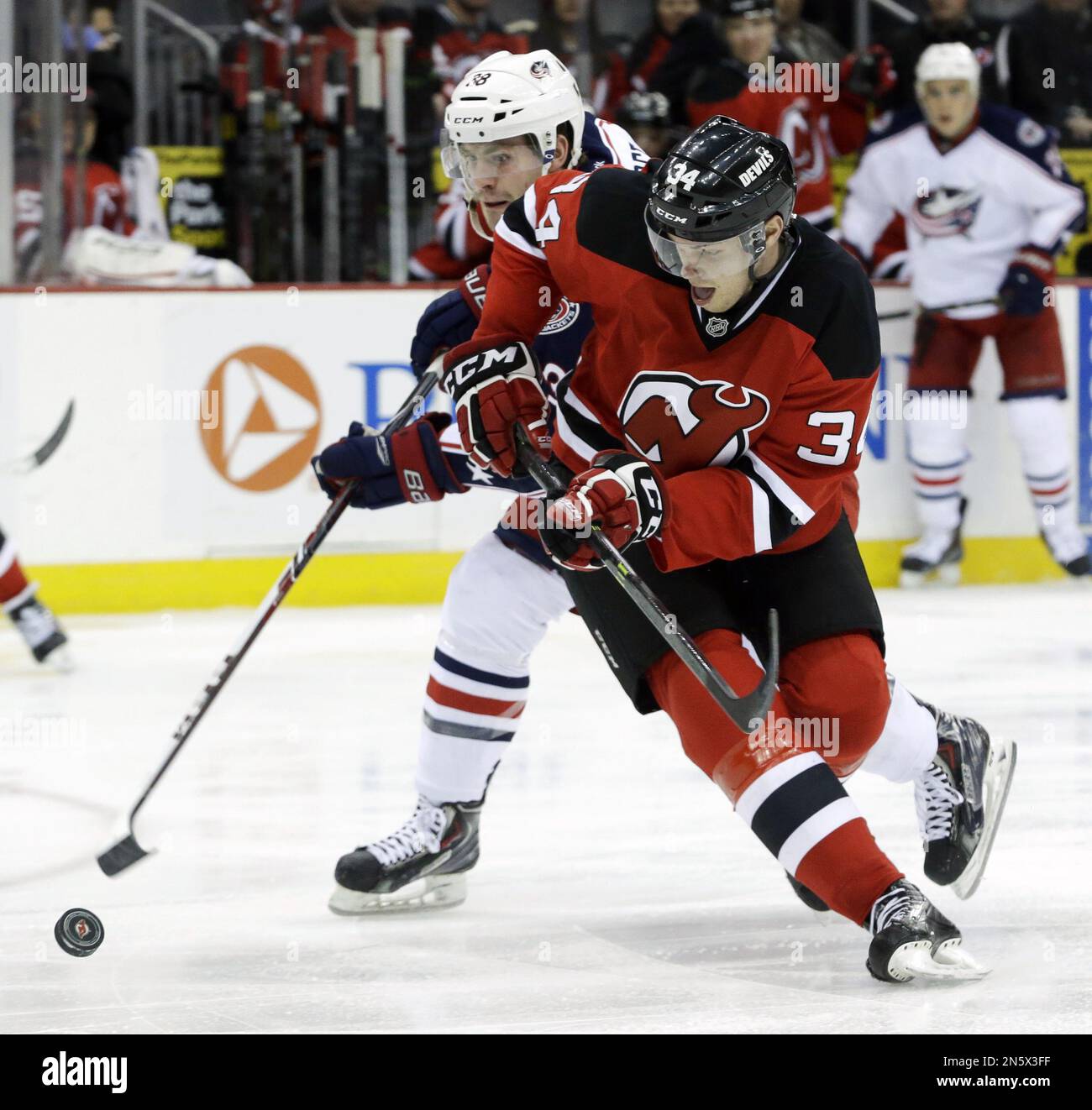 New Jersey Devils' Jon Merrill (34) and Columbus Blue Jackets' Boone ...