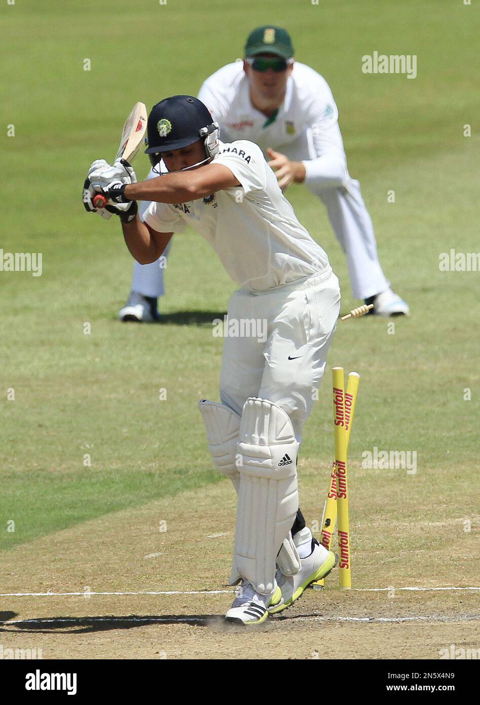 India's batsman Rohit Sharma, front, is bowled as South Africa's ...
