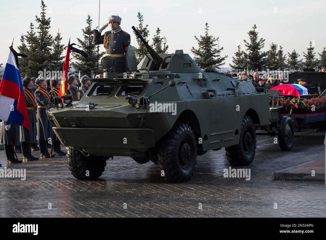 The honor guard's armored personnel carrier pulls a coffin bearing the ...