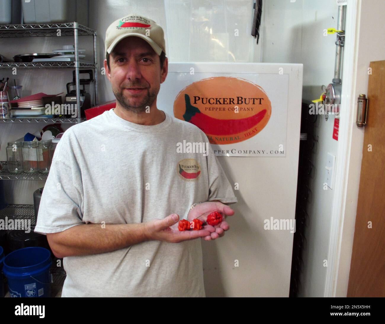 In this Dec. 12, 2013 photo, Ed Currie holds Carolina Reaper peppers ...