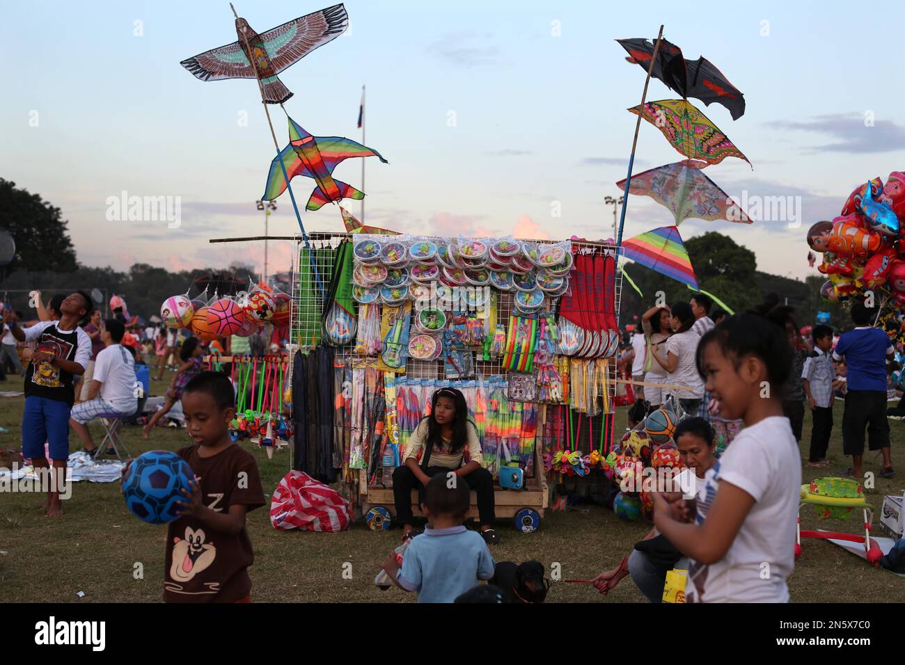A Filipino kite vendor waits for customers as a crowd gathers at Manila ...