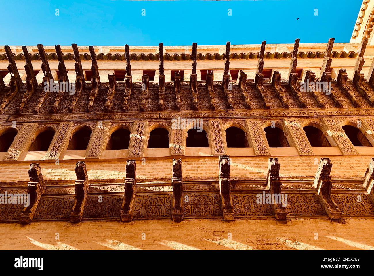 An impressive high-rise building with a distinct brown exterior and ...