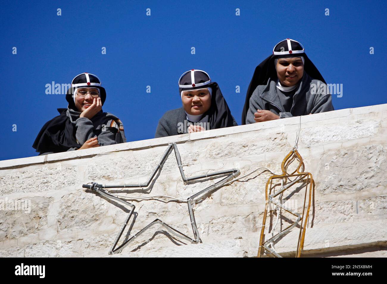 Christian nuns watch a Christmas celebration in Manger Square, outside ...