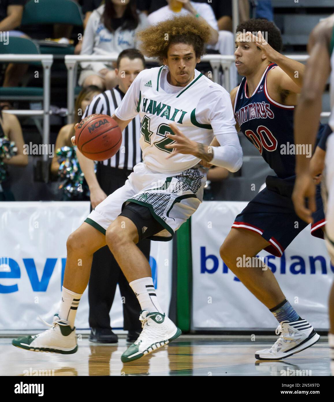 Hawaii forward Isaac Fotu (42) posts up against St. Mary's forward Brad ...