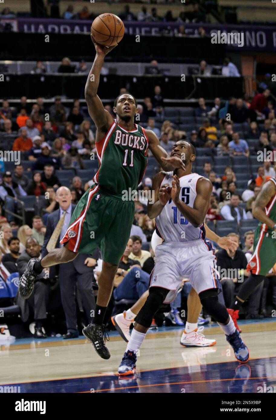 Milwaukee Bucks' Brandon Knight (11) drives past Charlotte Bobcats ...