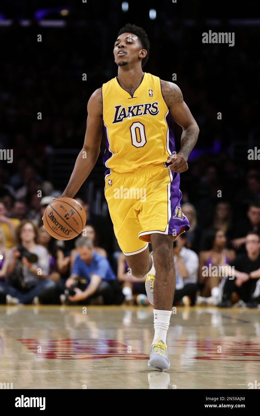 Los Angeles Lakers forward Nick Young brings the ball down court during ...