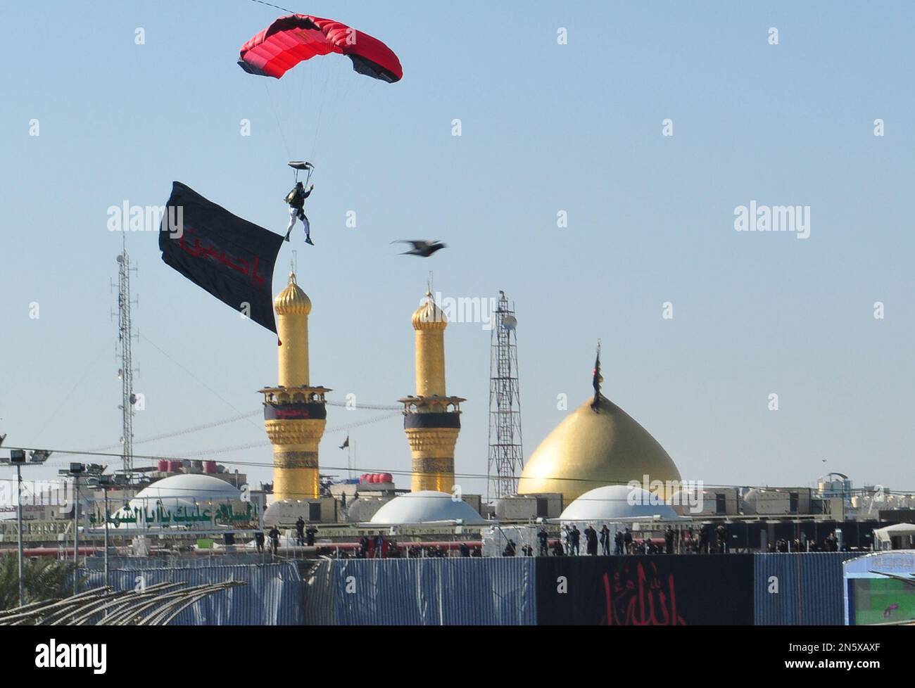 A member of Iraq's national skydiving team, prepares to land in front ...