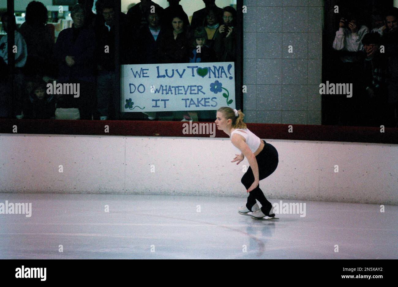Figure skater Tonya Harding skates past a sign of support as she ...