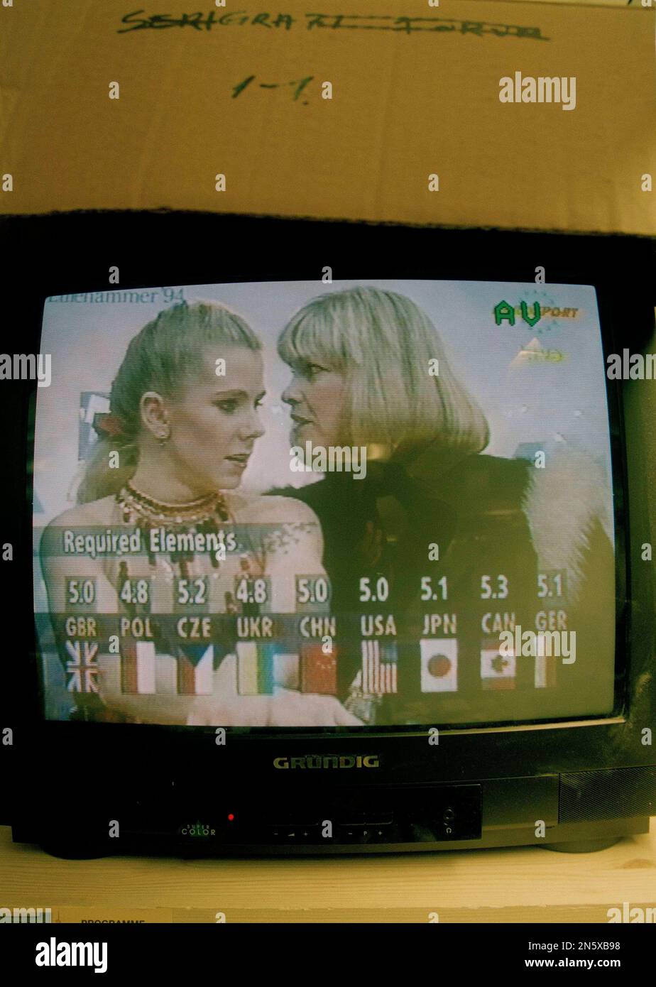 USA's Tonya Harding, left, and her coach Diane Rawlinson listen as ...