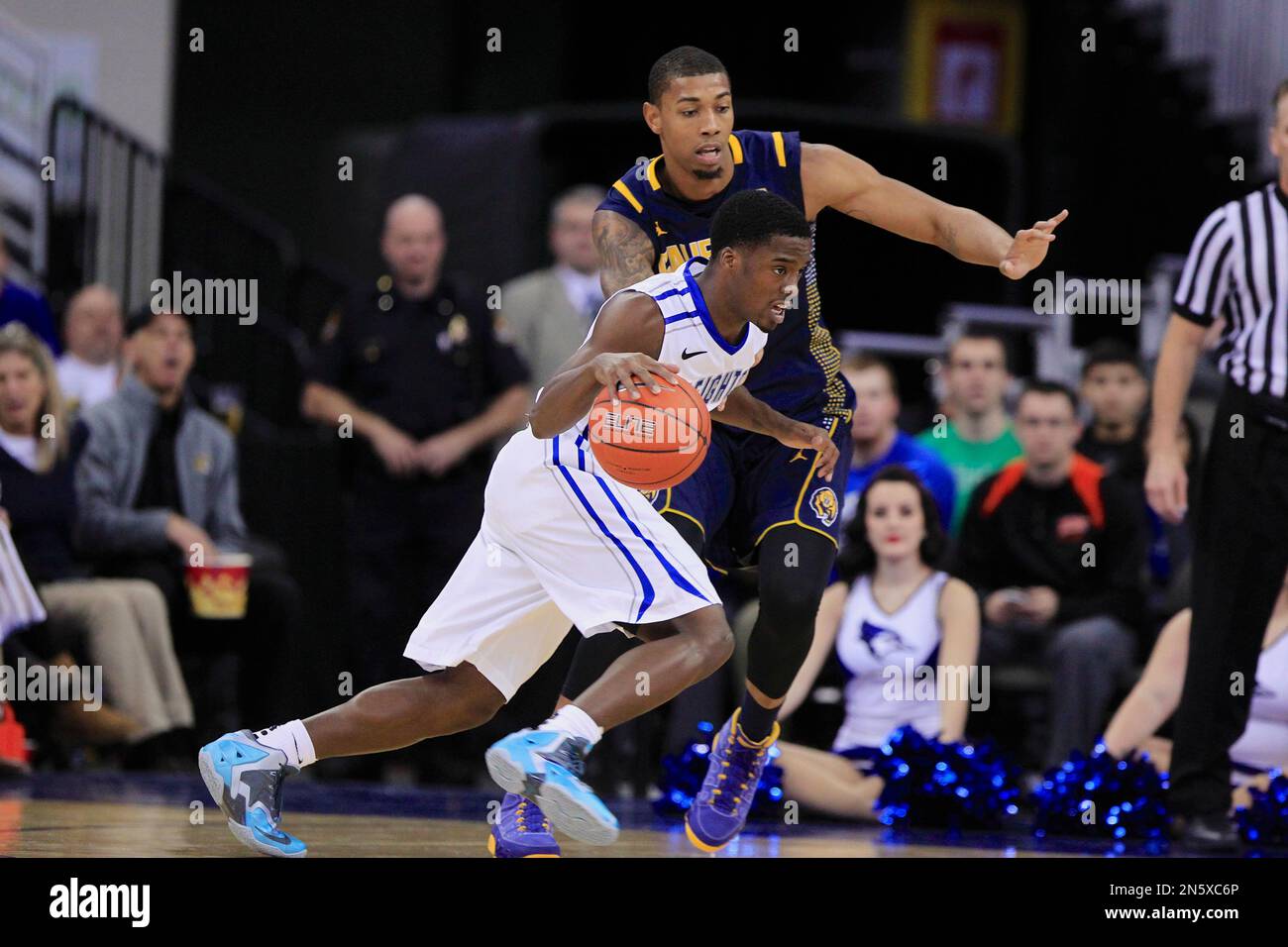 Creighton's Austin Chatman (1) drives past California's Richard Solomon ...