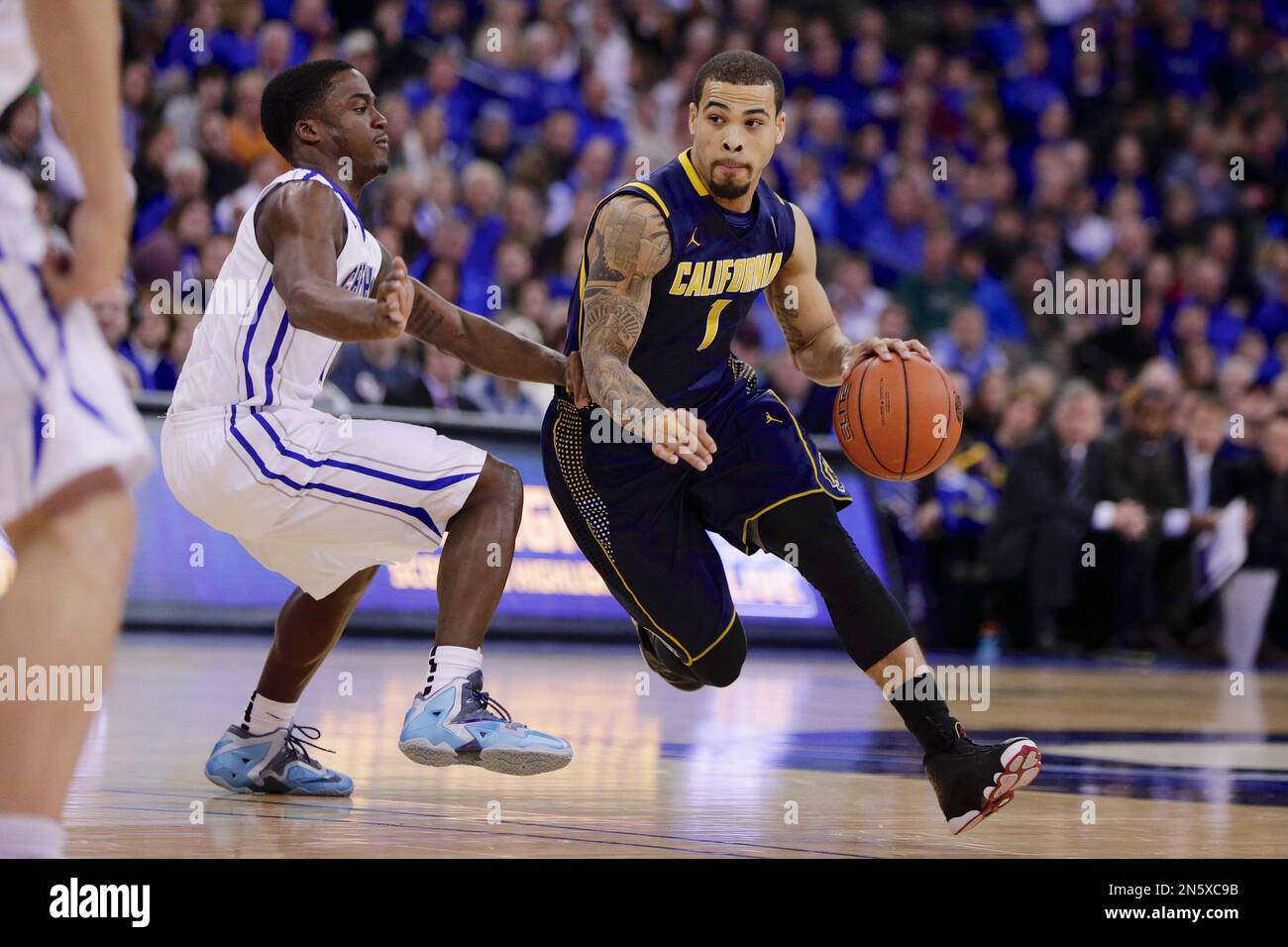California's Justin Cobbs (1) drives past Creighton's Austin Chatman ...