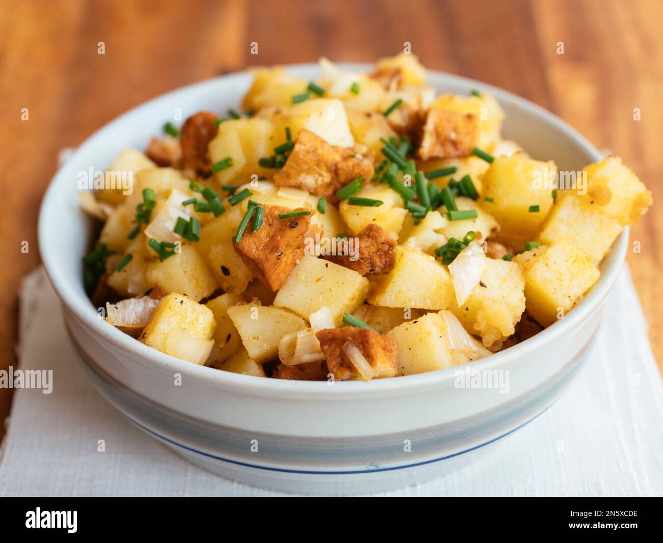 Warm Vegan German Potato Salad with Spicy Tofu Pieces Stock Photo - Alamy