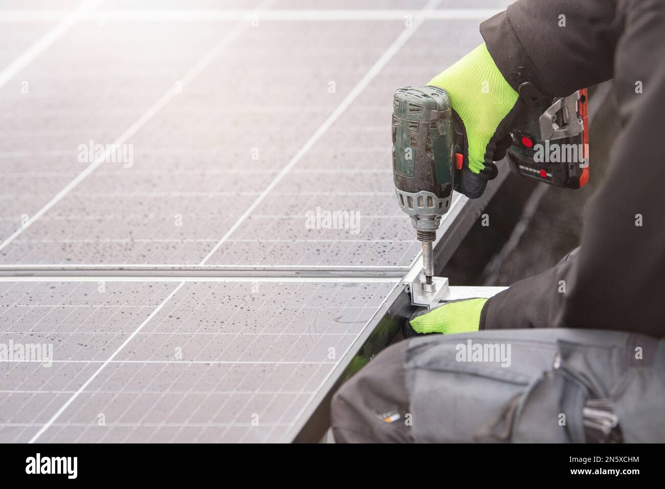 The solar panel installer twists the modules together using aluminum ...