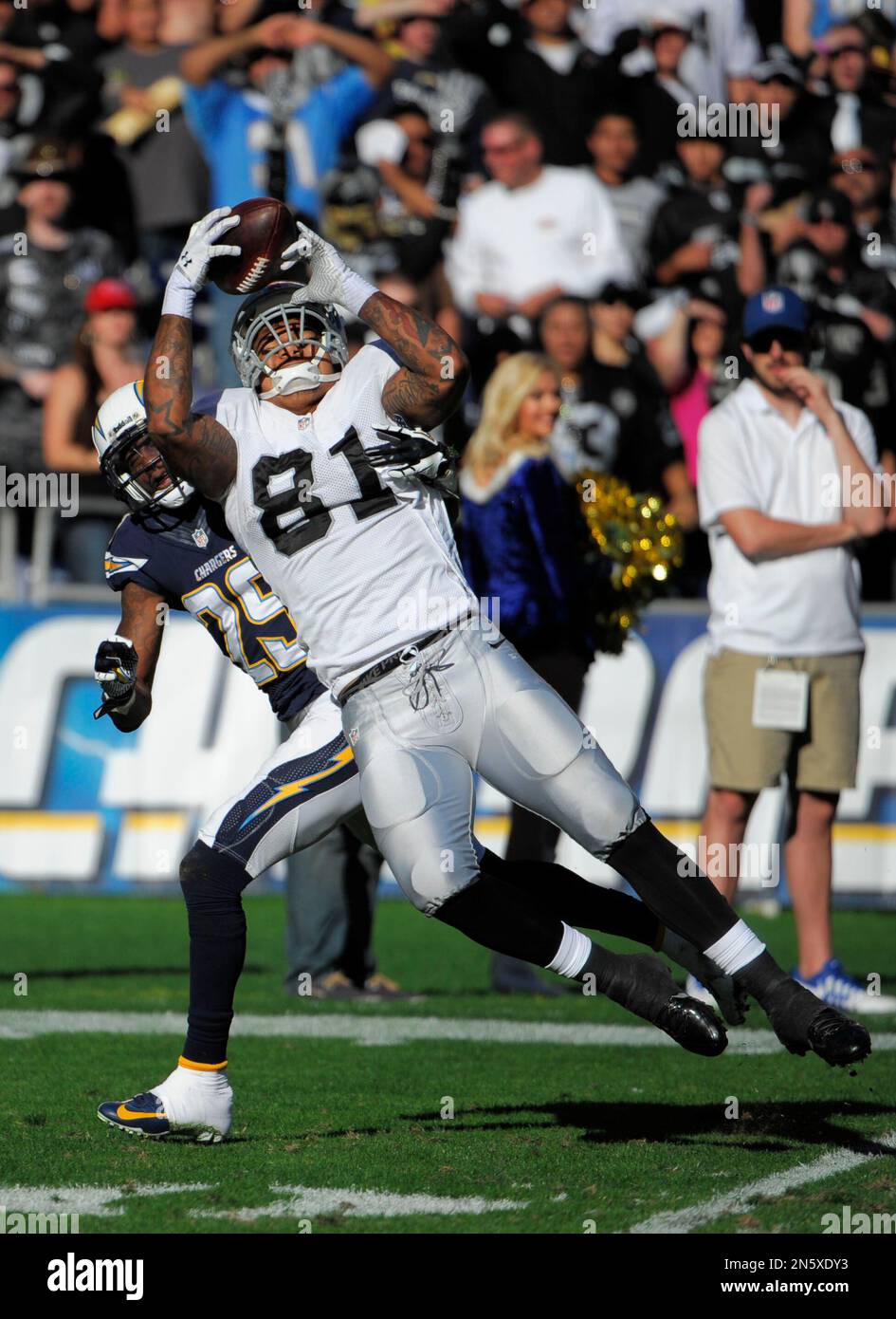 Oakland Raiders tight end Mychal Rivera (81) hauls in a pass in front ...