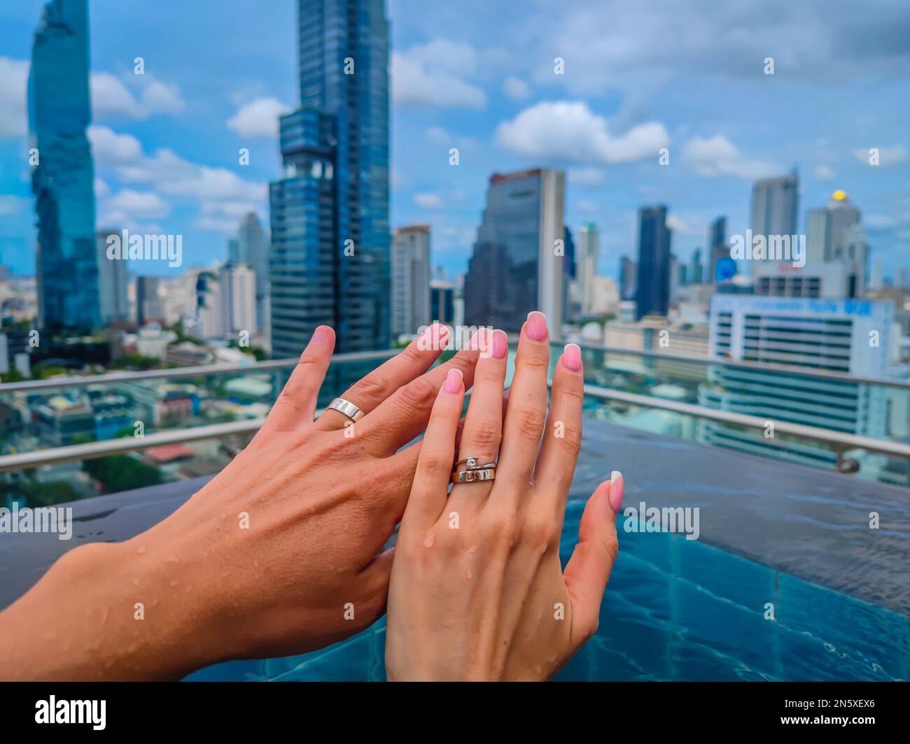 Hands with rings of just engaged and married couple with a Bangkok ...
