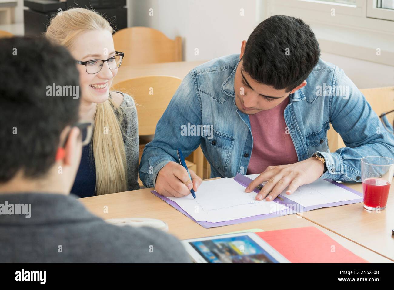 University students studying in canteen and having lunch School ...