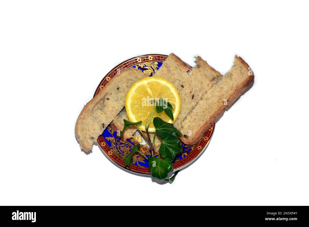 Toast bread with a lemon slice in a small bowl isolated on a white ...