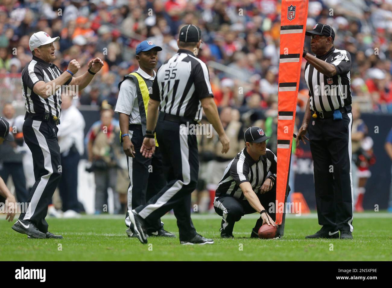 NFL referees measure a spot during the first quarter of an NFL football ...