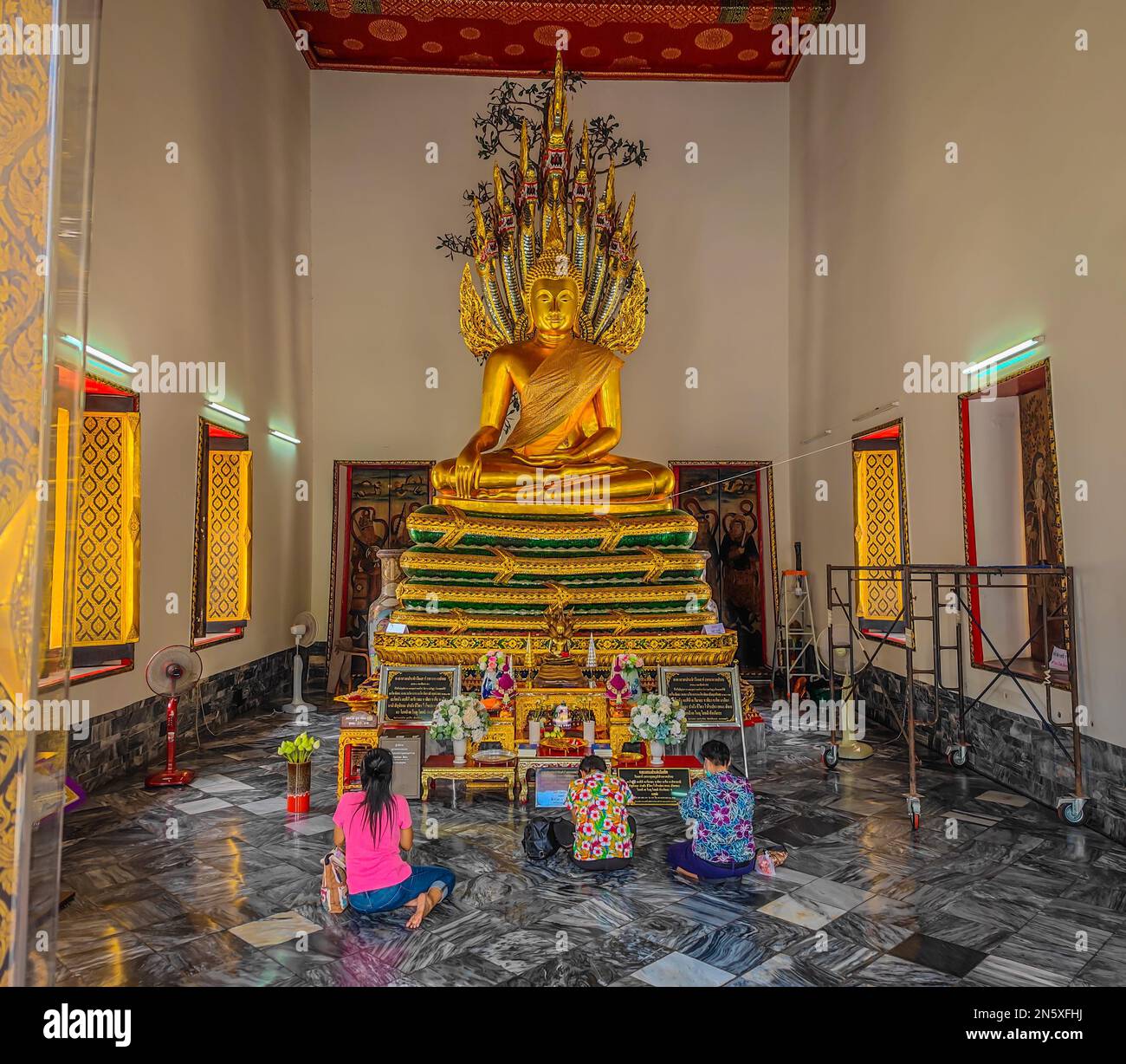 Asian people in a temple in Bangkok are praying in front of Buddha ...