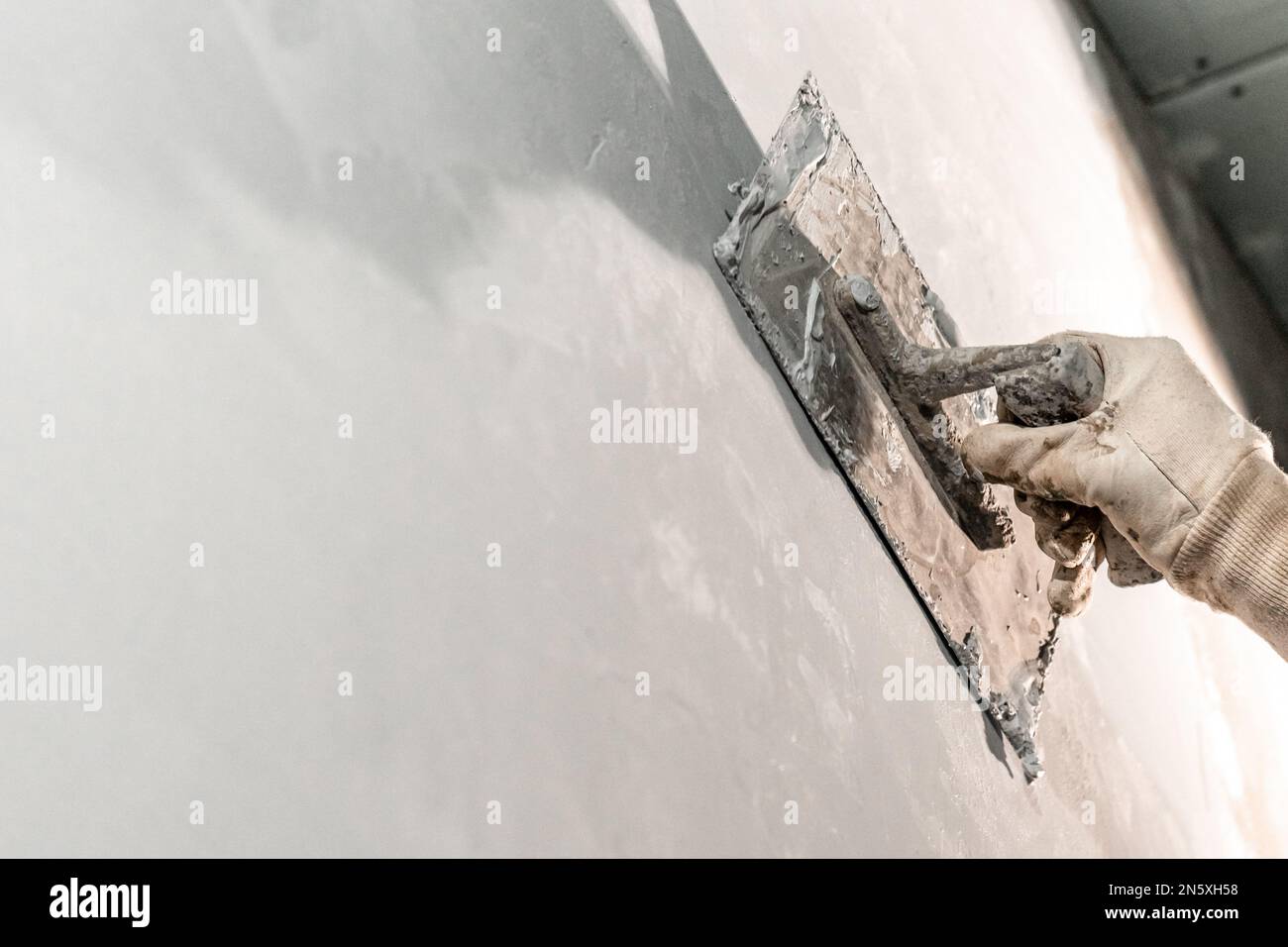 manual work with a trowel for waterproofing the wall Stock Photo - Alamy