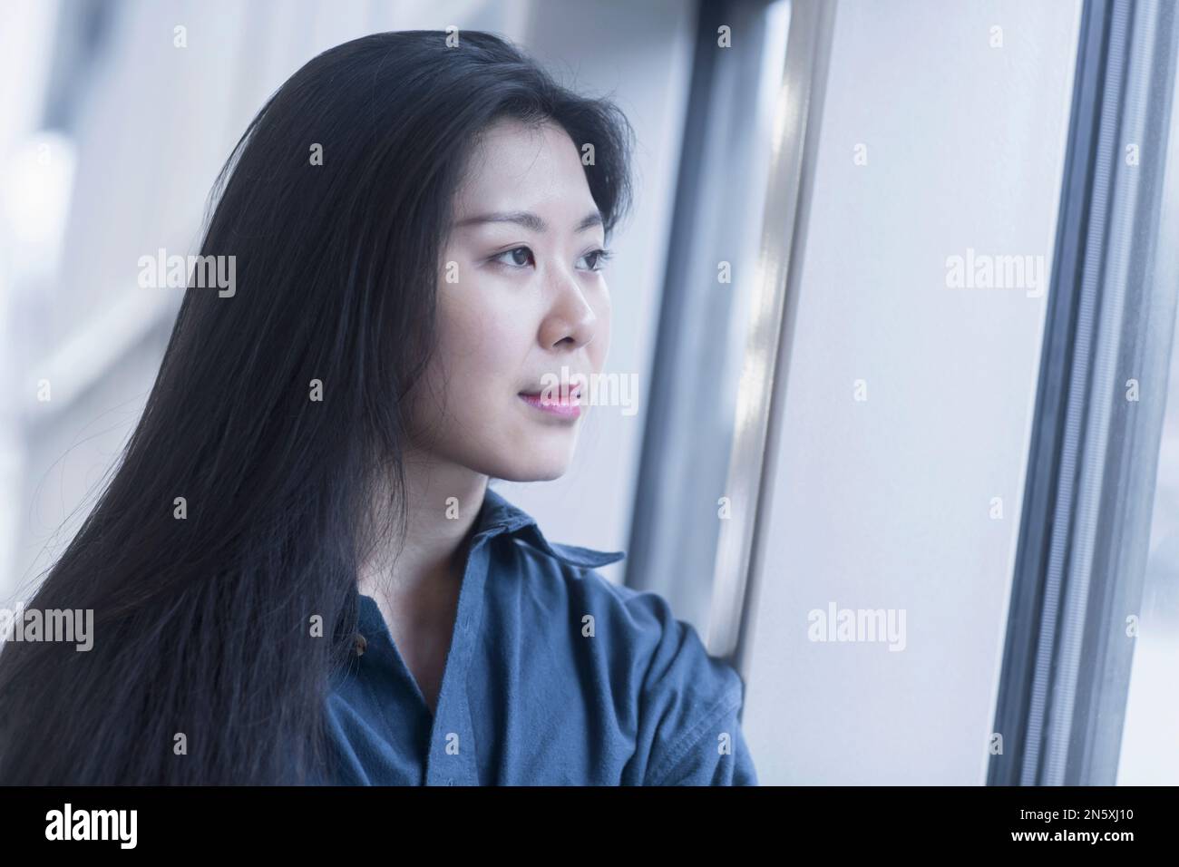 Young asian woman through window hi-res stock photography and images ...