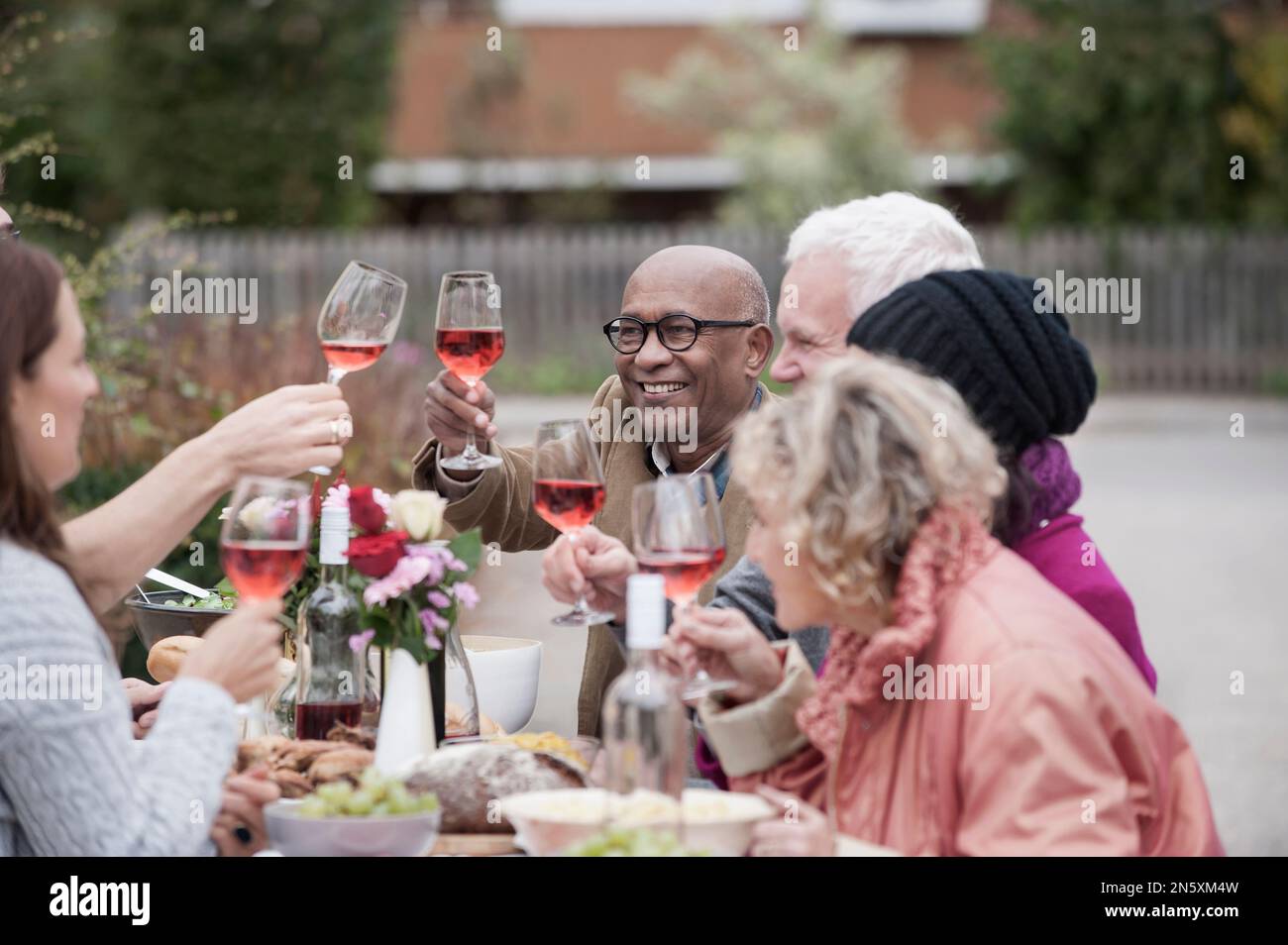 Family and friends enjoying outdoor party at farmhouse, Bavaria ...