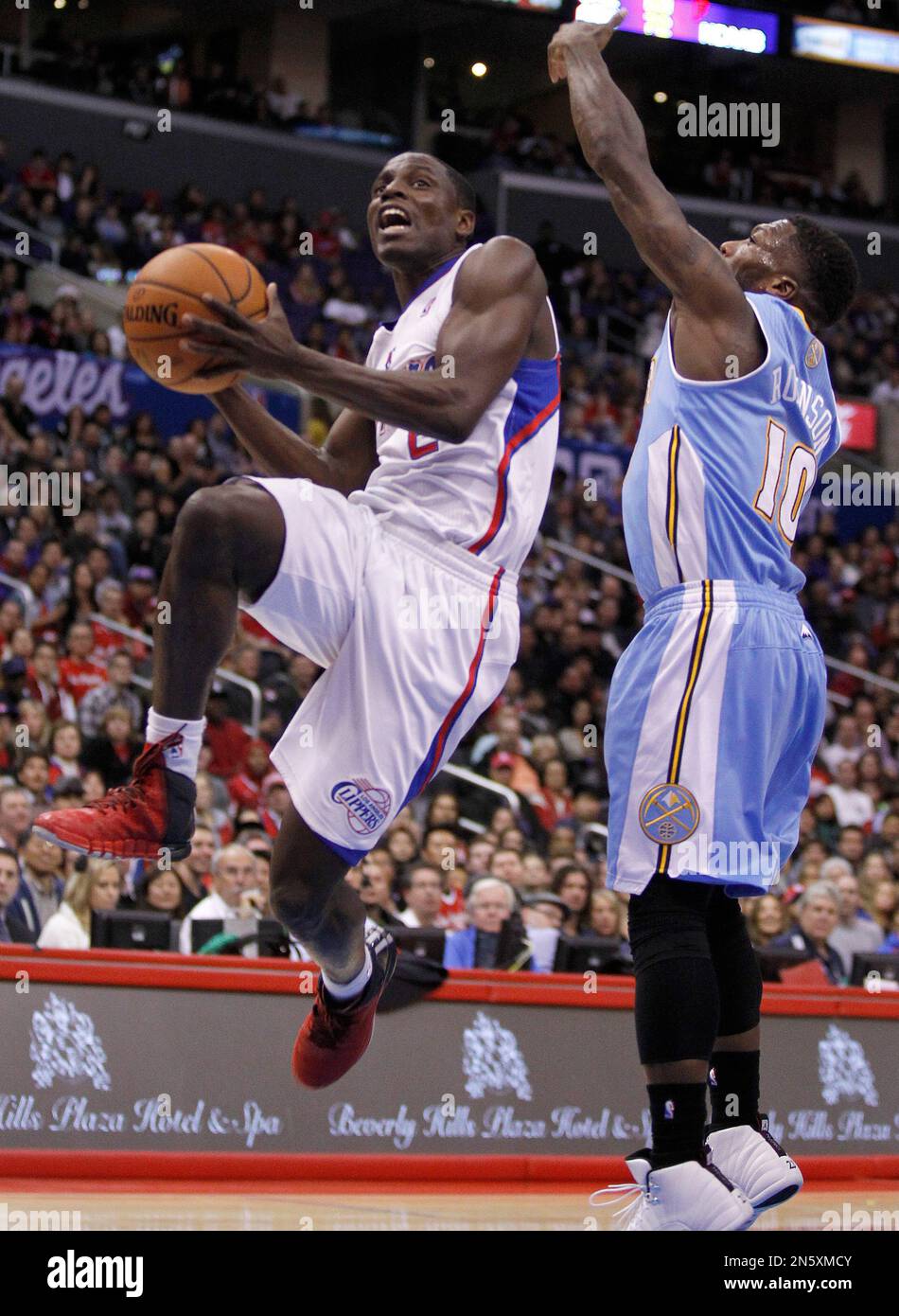 Los Angeles Clippers guard Darren Collison, left, gets past Denver ...