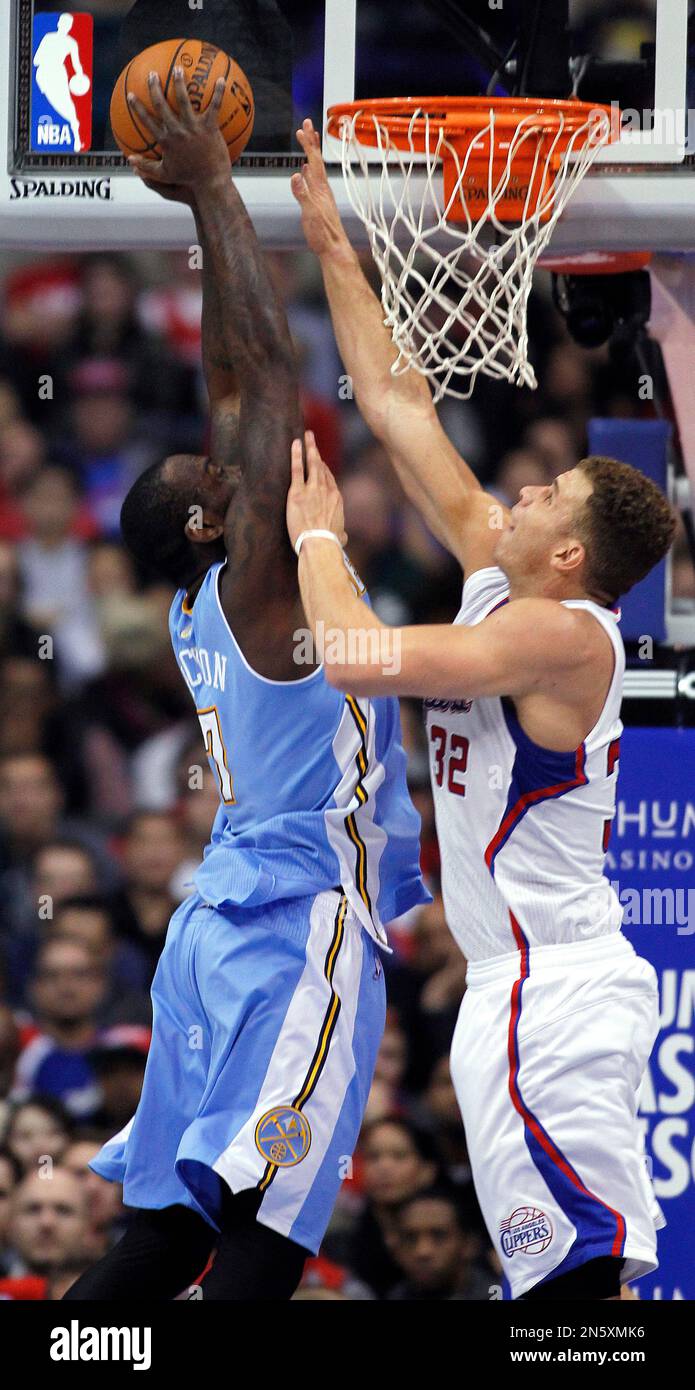 Denver Nuggets forward J.J. Hickson, left, goes up to the basket with ...
