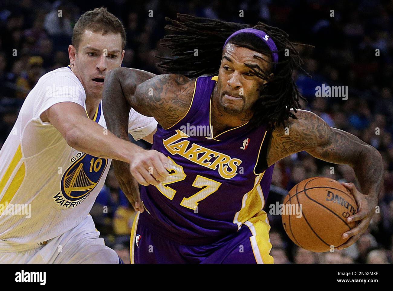 Los Angeles Lakers' Jordan Hill, right, drives the ball against Golden ...