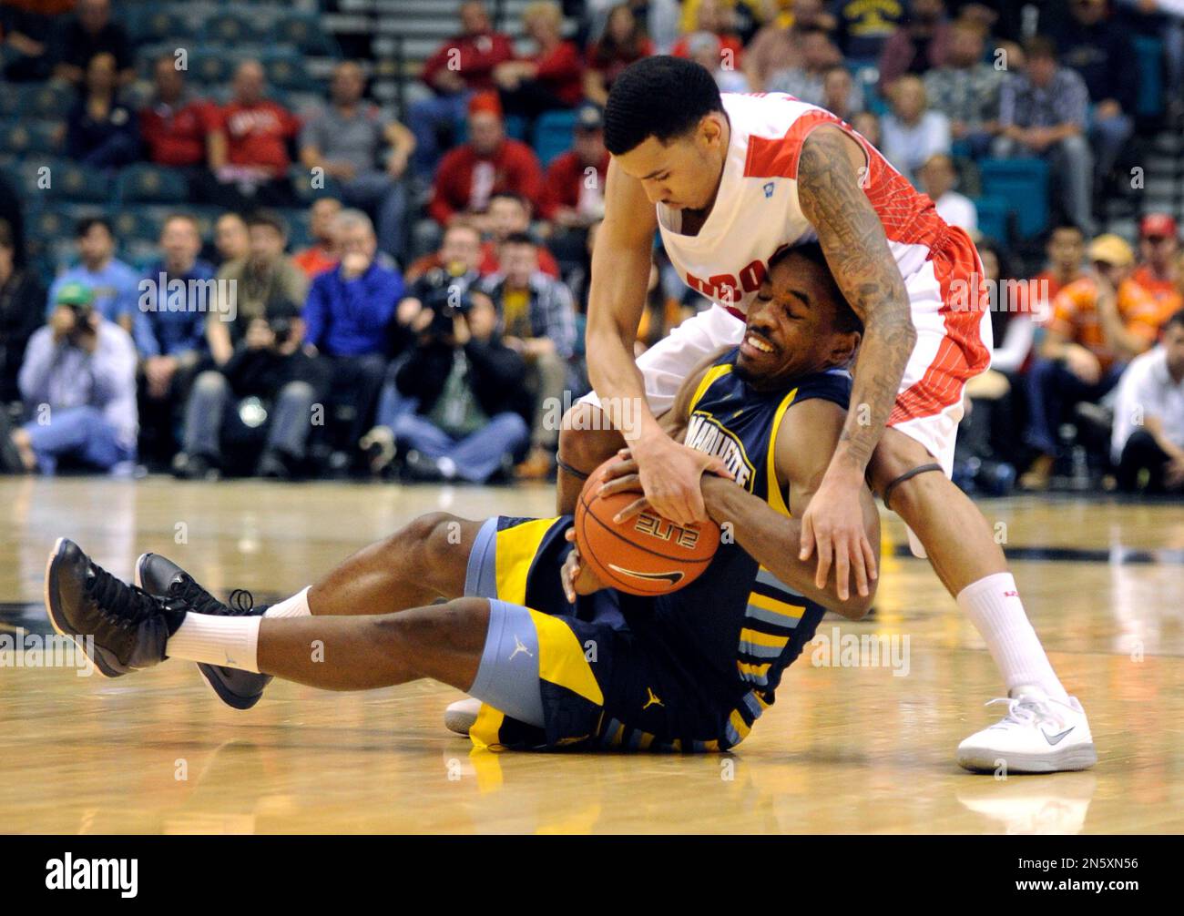 Marquette's Derrick Wilson, bottom, and New Mexico's Kendall Williams ...