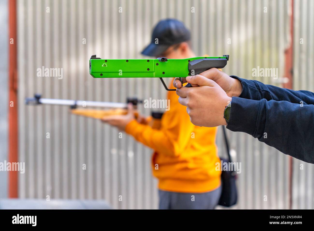 Hand-held laser sports pistol while aiming Stock Photo - Alamy