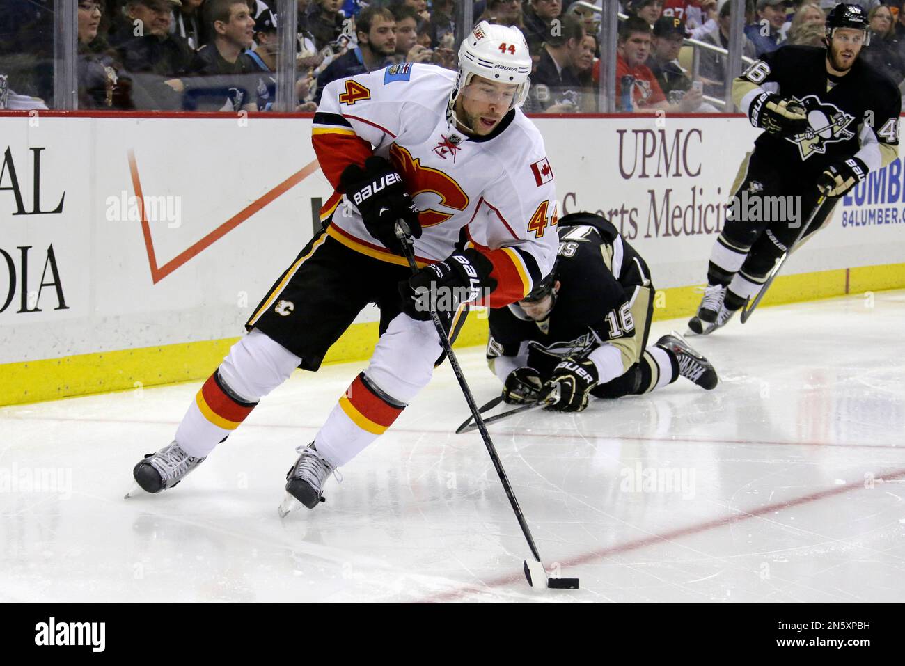 Calgary Flames defenseman Chris Butler (44) clears the puck in the ...
