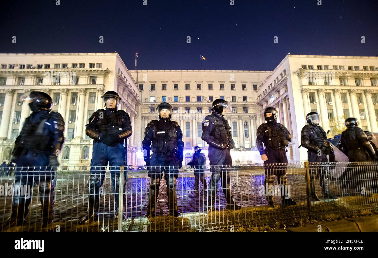Riot police officers in combat gear guard the interior ministry ...