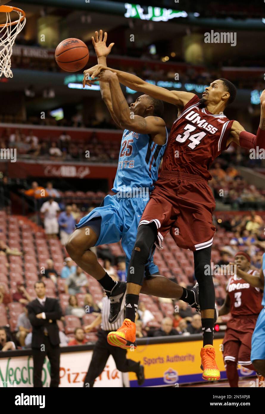 Massachusetts forward Raphiael Putney (34) blocks a shot by Florida ...