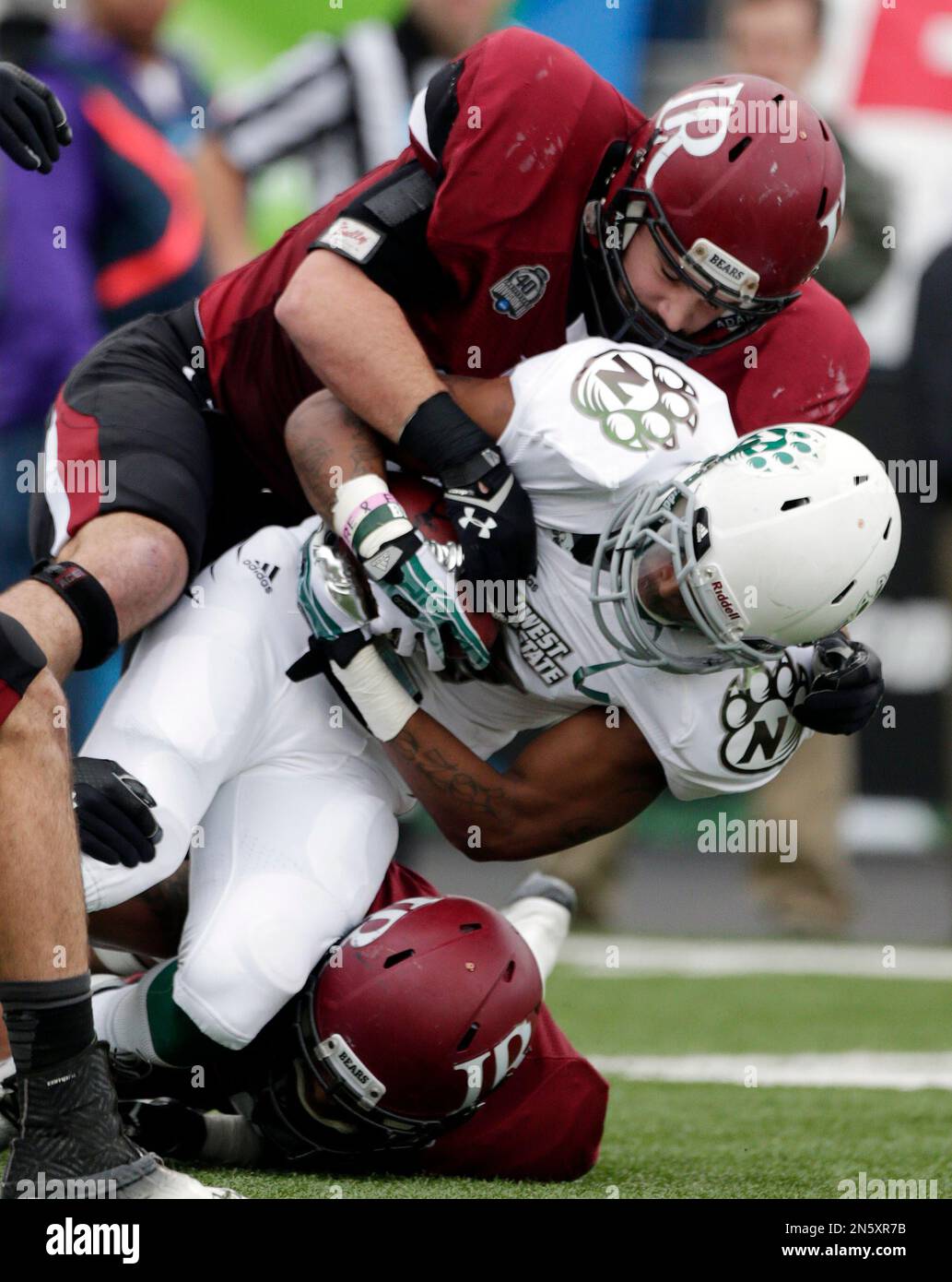 NW Missouri State receiver Reuben Thomas (12) is taken down by Lenoir ...