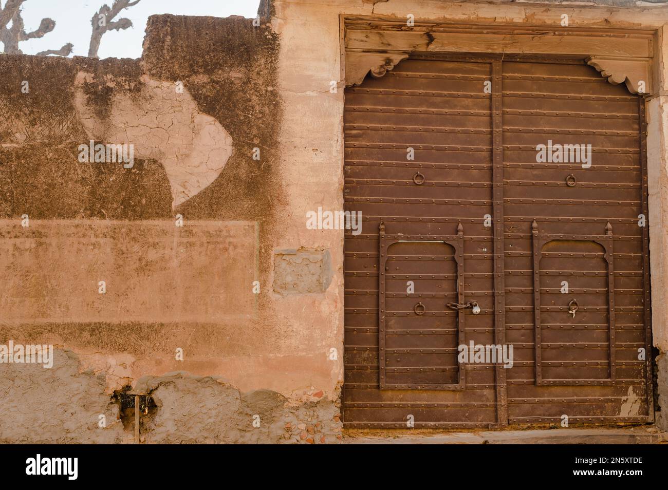 An old gate with two knockers and a latch, in Mandawa haveli Rajasthan ...