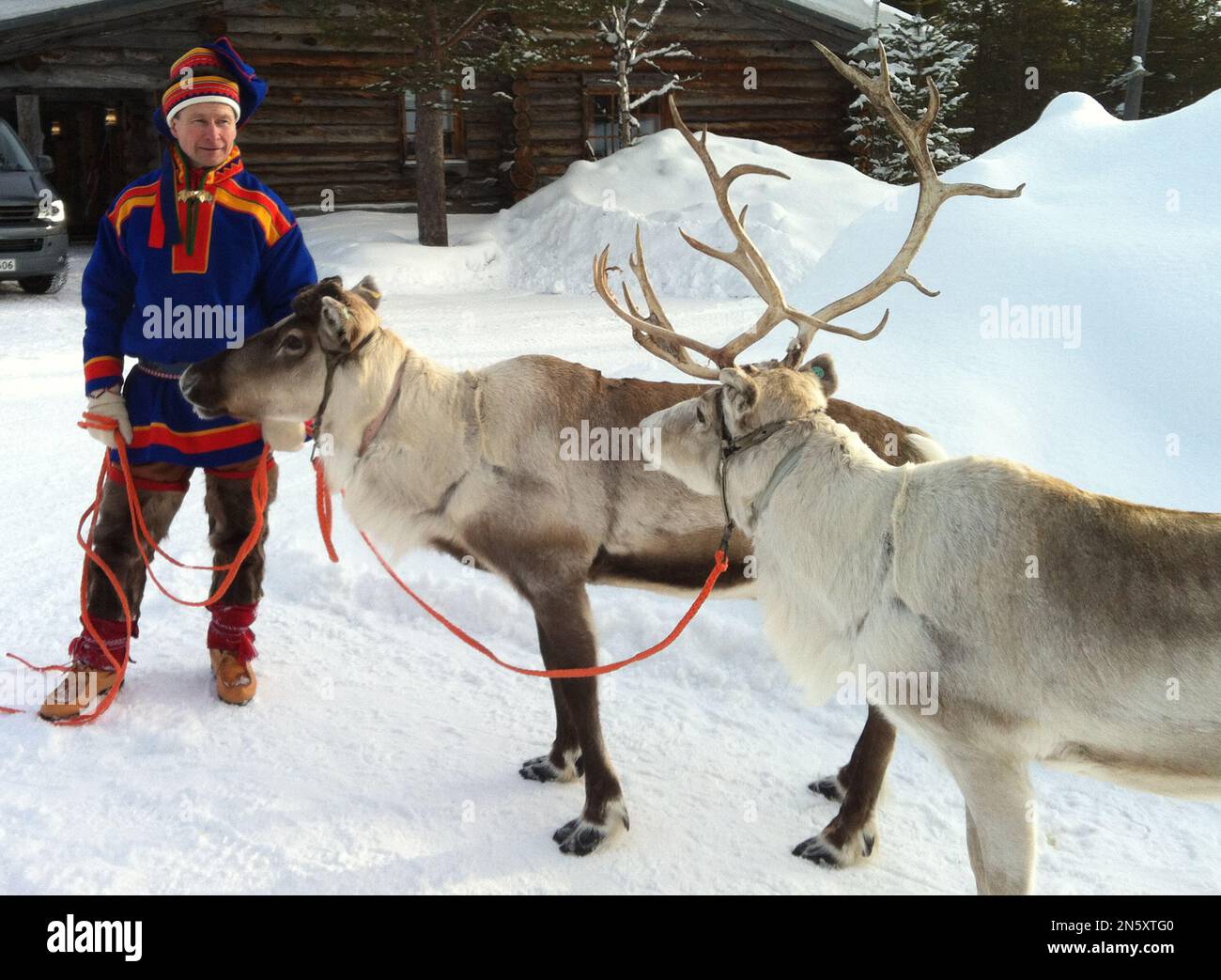 In this March 2013 photo, A Sami handler in traditional clothing holds ...