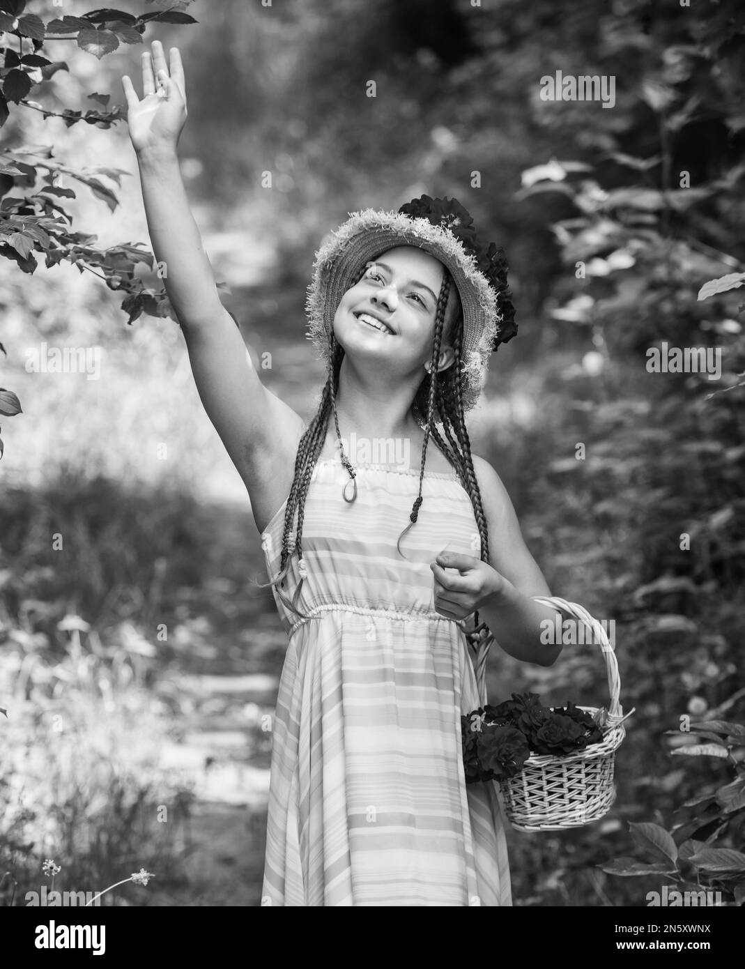 enjoy green nature. gather flower bouquet in basket. happy teen girl in ...