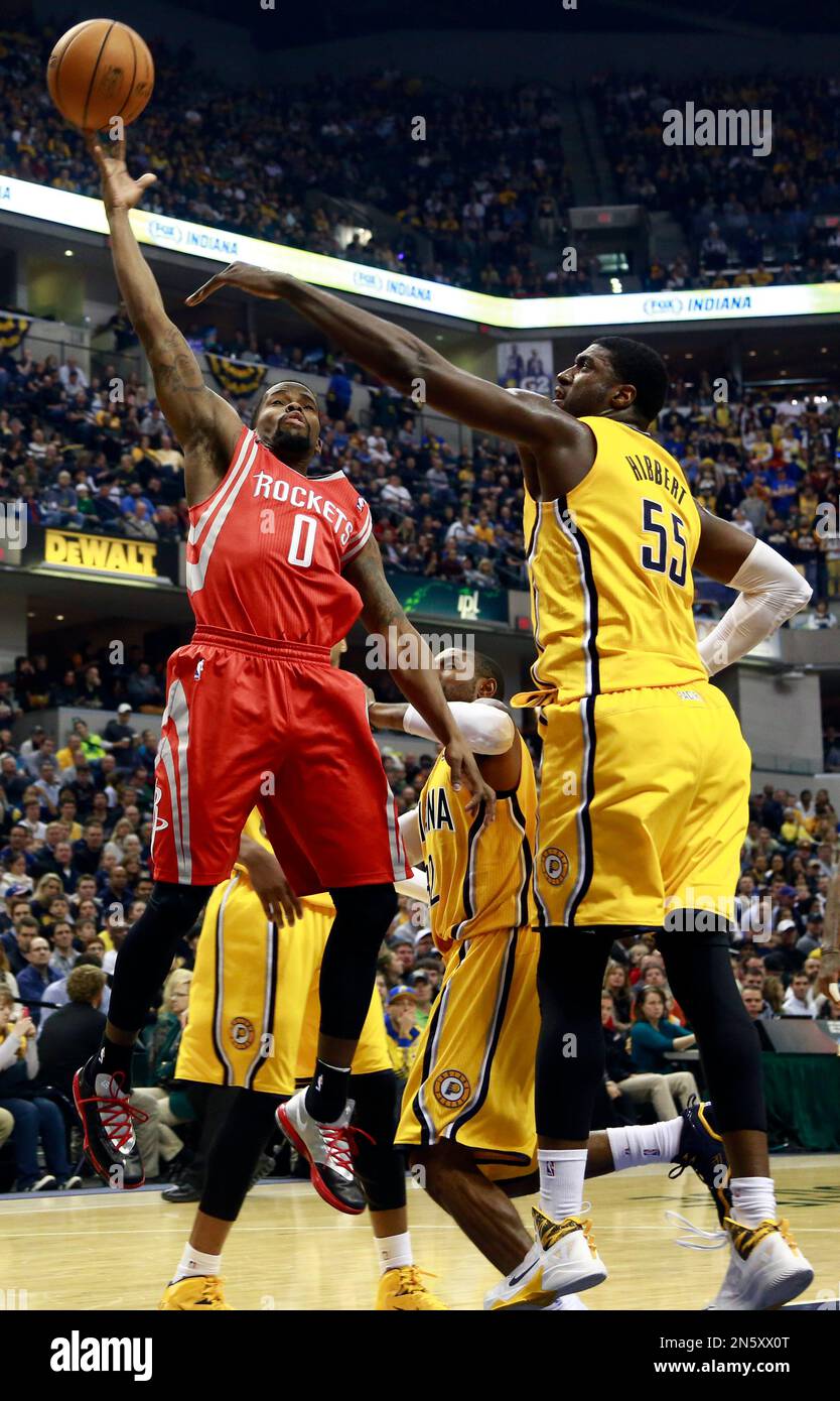 Houston Rockets guard Aaron Brooks (0) shoots while defended by Indiana ...