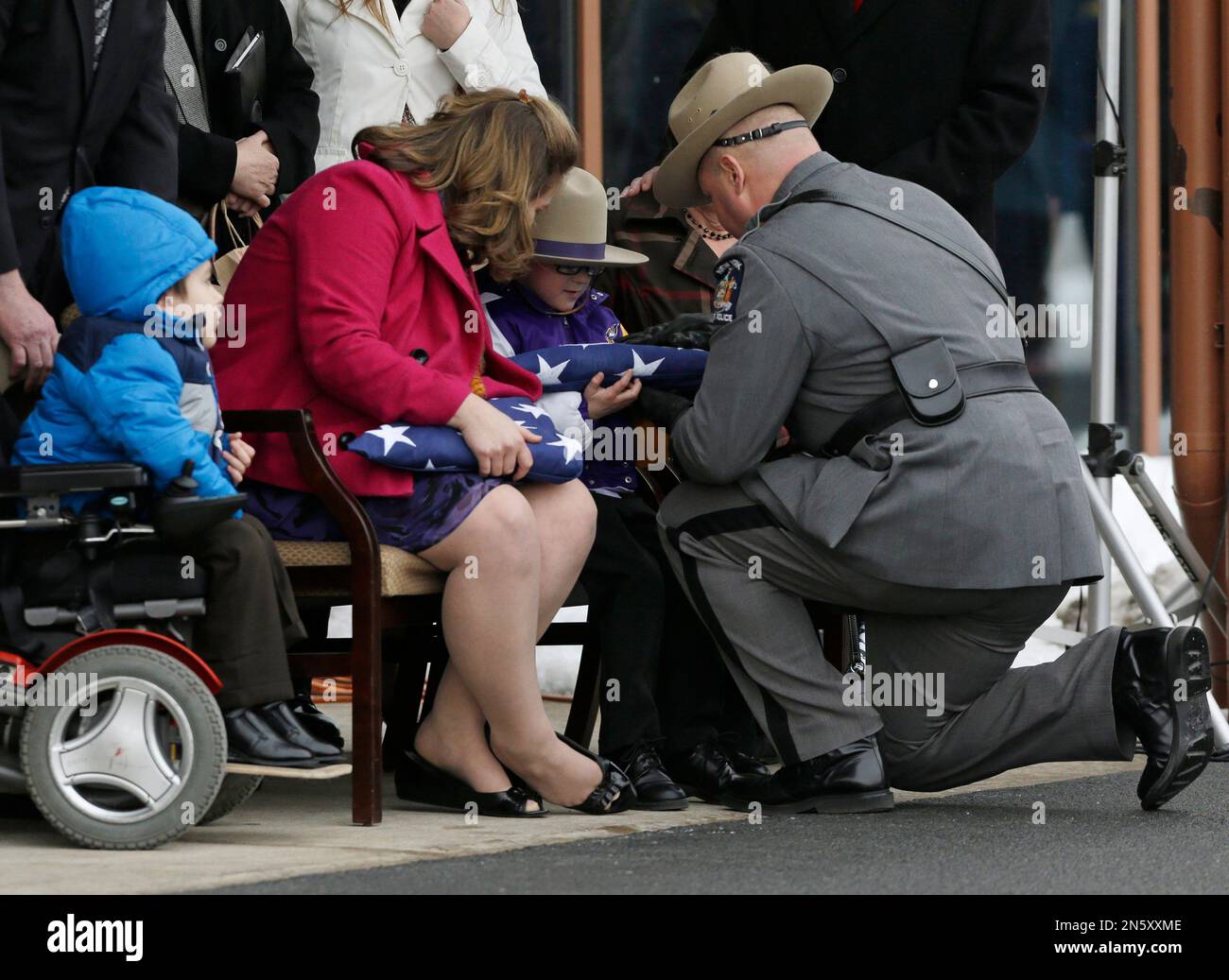 New York State Trooper W.S. Claus, right, presents a flag to Zachary ...