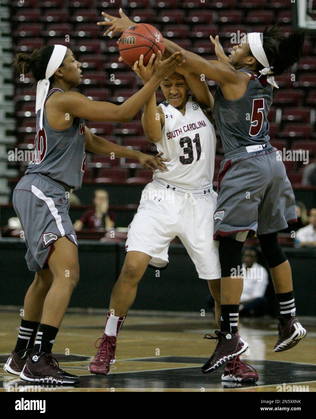 South Carolina's Asia Dozier (31) gets double teamed by Winthrop's ...
