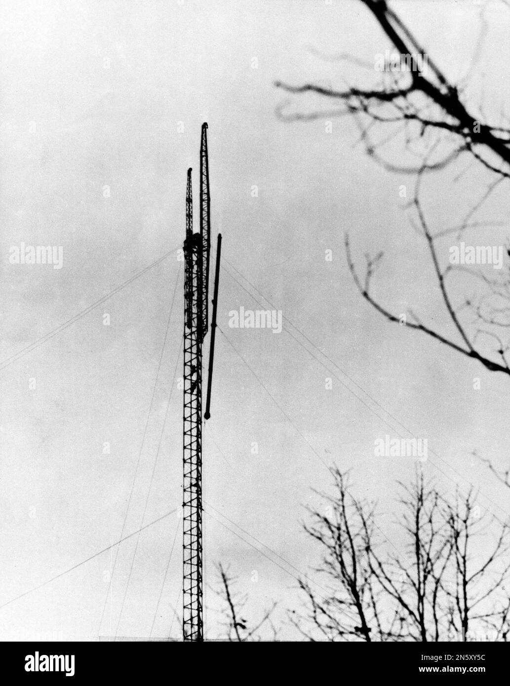 A 13.5 ton antenna is hoisted to the top of the 900 foot tower that ...