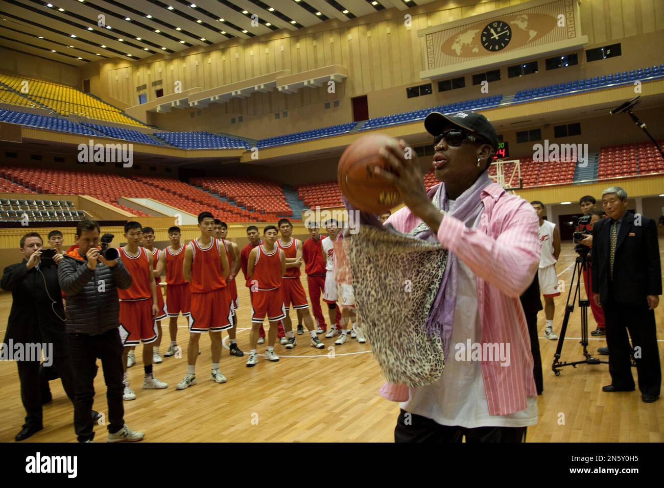 Former NBA basketball star Dennis Rodman takes a jump shot as he gives ...