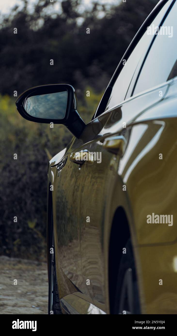 A vertical shot of a Volkswagen Arteon gold color Stock Photo - Alamy