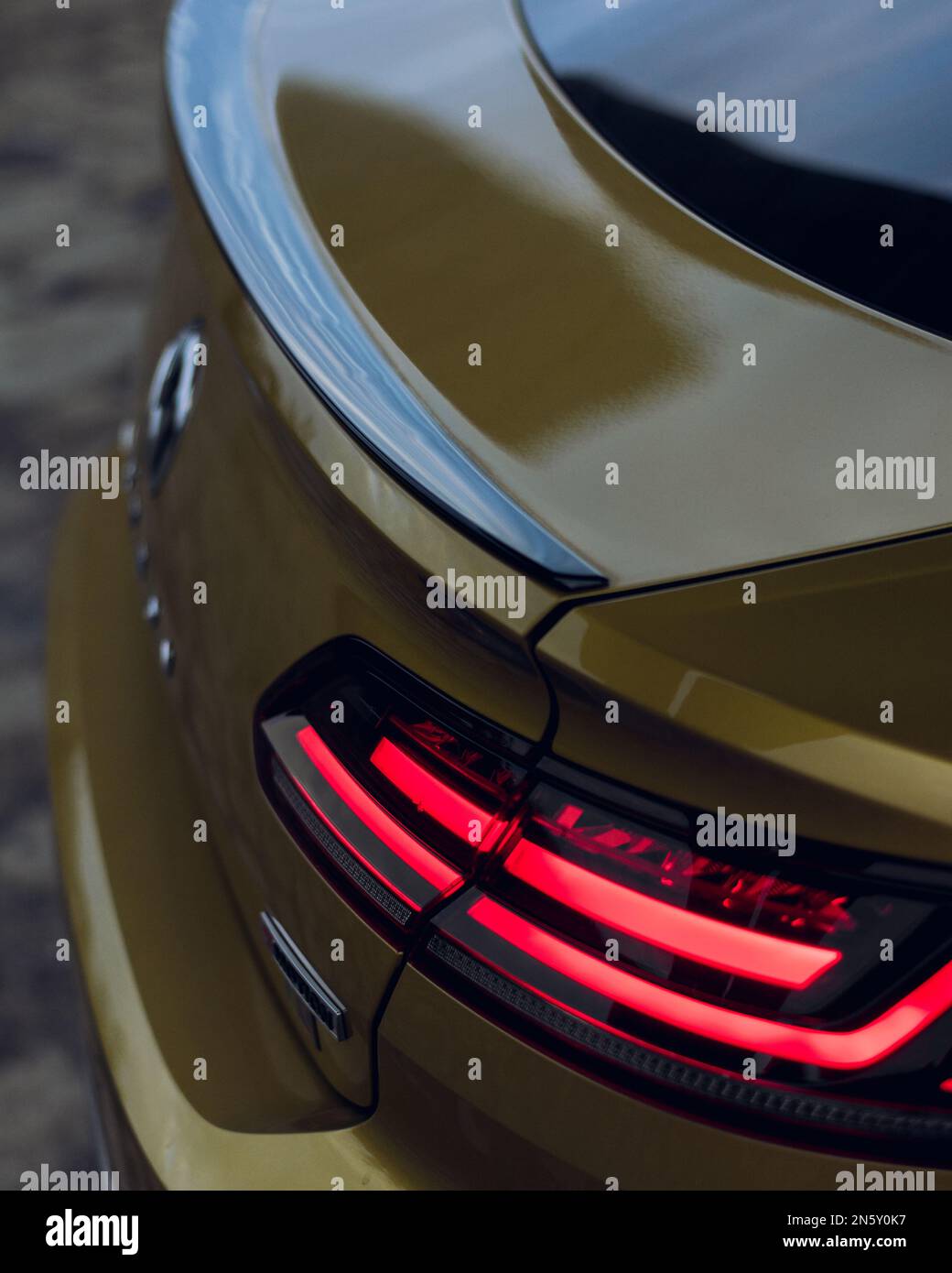 A vertical shot of the back of a Volkswagen Arteon gold color Stock ...